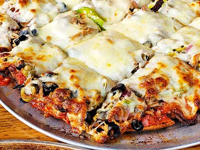 The thick-crust pizza achieves the impossible: maintaining structural integrity while delivering that perfect cheese-to-sauce-to-crust ratio in every bite.
