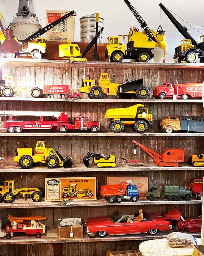 Toy trucks and cars that survived actual childhoods, built when toys were made to last through generations of play.