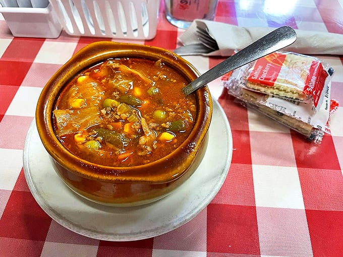 The legendary vegetable soup that locals line up for – a hearty tomato broth packed with veggies and memories.