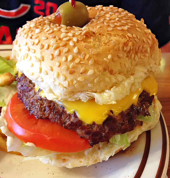 The cheeseburger arrives like an old friend&mdash;unpretentious yet magnificent, with melty American cheese and that signature olive topper.