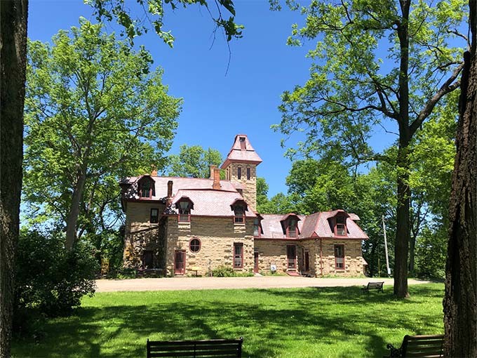 Piatt Castle Mac-A-Cheek stands proudly in a sun-dappled clearing, its stone walls and tower a testament to 19th-century architectural ambition.