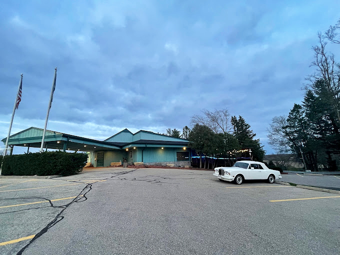 Golf course charm meets culinary ace. This supper club's exterior is as inviting as a perfect summer day.