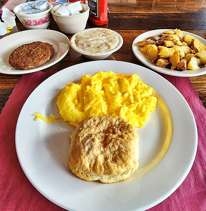 Sunshine-yellow eggs, golden potatoes, and a biscuit that would make any Southern grandmother nod in approval &ndash; breakfast perfection on a plate.