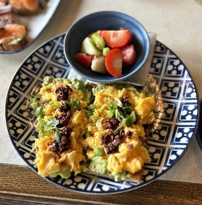 Breakfast meets art gallery in this vibrant plate&mdash;scrambled eggs and avocado creating a canvas of comfort that morning dreams are made of.