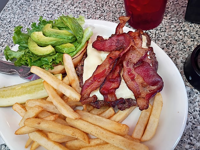 When lunch calls, this beauty answers &ndash; a juicy burger topped with crispy bacon and fresh avocado that requires both hands and several napkins.