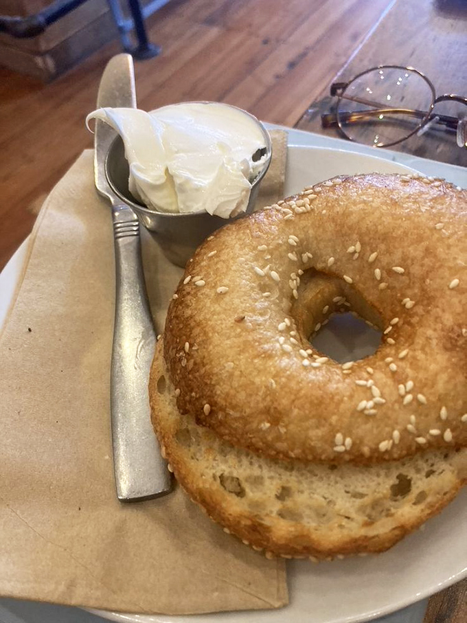 A sesame bagel with cream cheese served simply because perfection needs no embellishment.