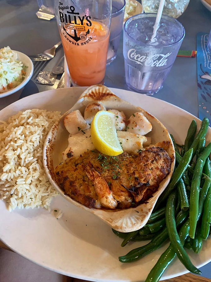 Succulent shrimp nestled in their ceramic boat, swimming in butter and crowned with seafood stuffing &ndash; a delicious voyage for your taste buds.