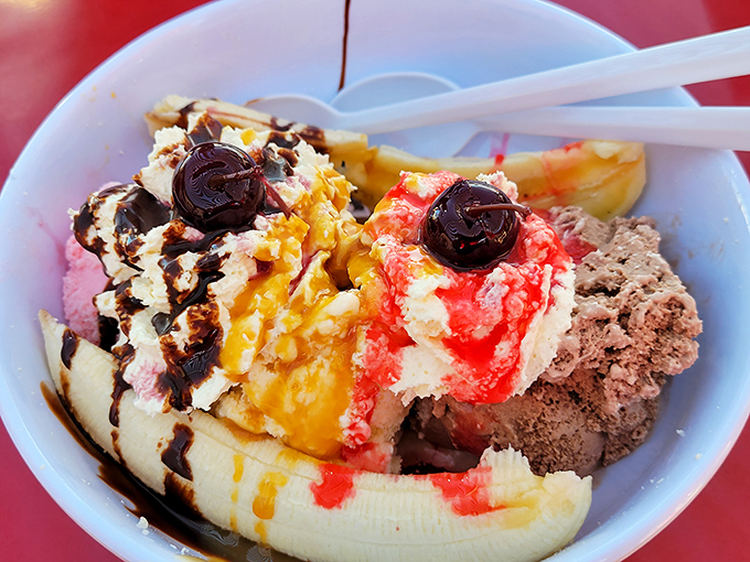 Dessert architecture at its finest – this banana split delivers three distinct flavor experiences in one gloriously excessive package.