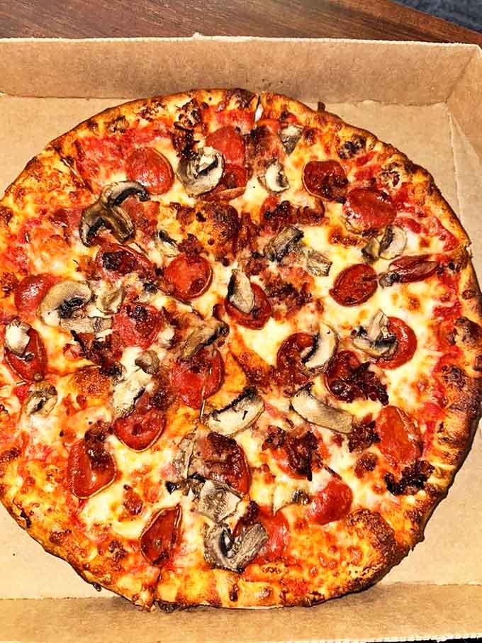 The holy trinity of pizza toppings creates a harmonious balance of savory flavors that dance across your taste buds.