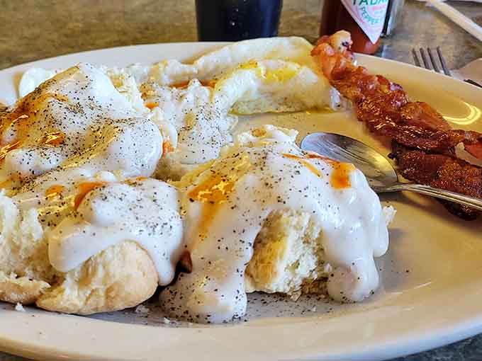 Those fluffy biscuits swimming in sausage gravy alongside bacon strips create the kind of plate that makes diet plans spontaneously combust.