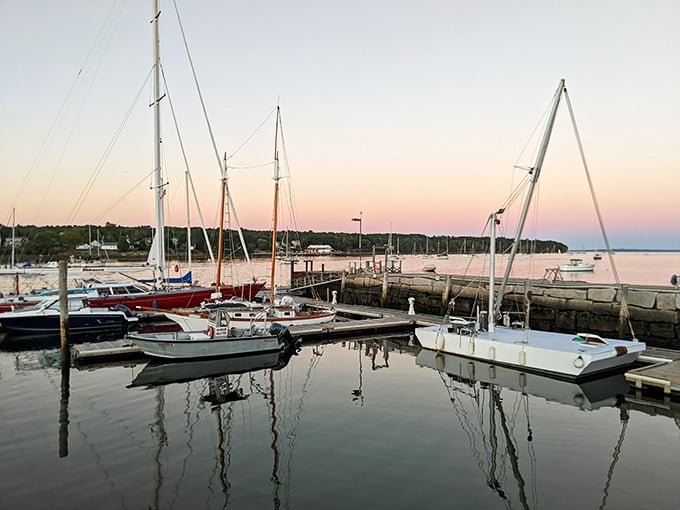 Sailboats bob gently at sunset in Belfast Harbor, creating a postcard-perfect scene that whispers, "Slow down, you're in Maine now."