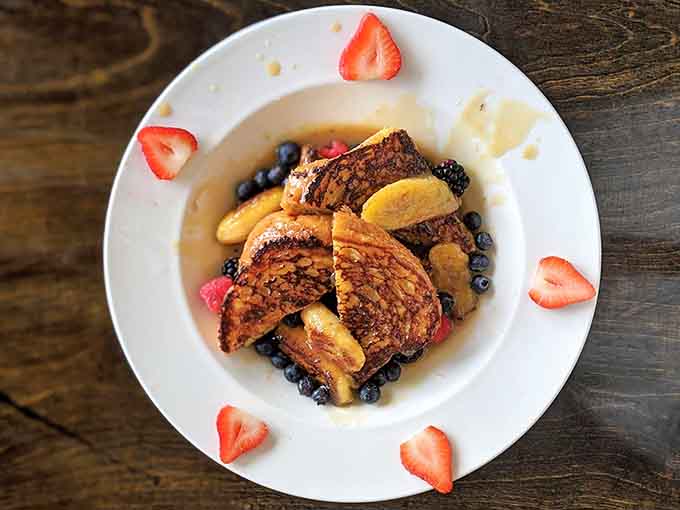 Thick, custardy, and golden-brown perfection topped with fruit that actually tastes like fruit, this is French toast's final evolutionary form.