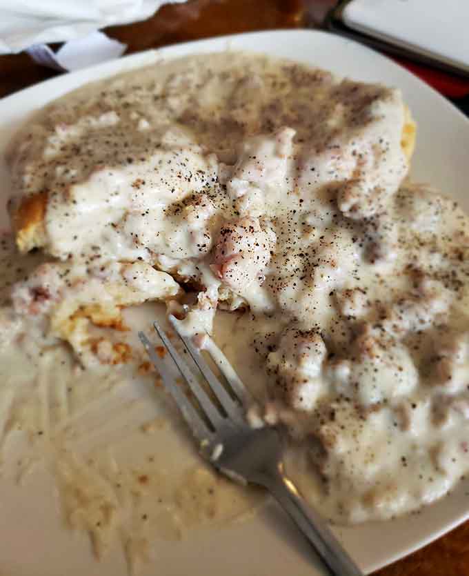 This close-up reveals the perfect gravy-to-biscuit ratio that separates the amateurs from the breakfast masters.