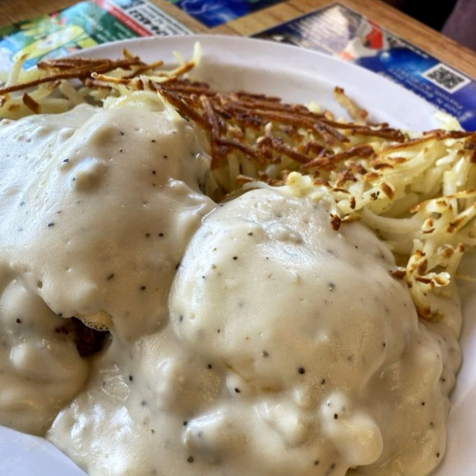 Biscuits smothered in rich gravy, paired with golden, crispy hashbrowns; a simple breakfast that feels like pure comfort on a plate.