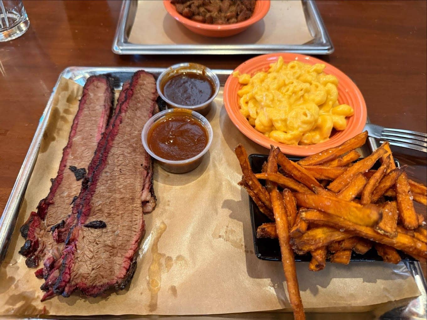 This brisket plate showcases Black Dog's smoking expertise, but those sweet potato fries steal the spotlight with their irresistible golden crunch.