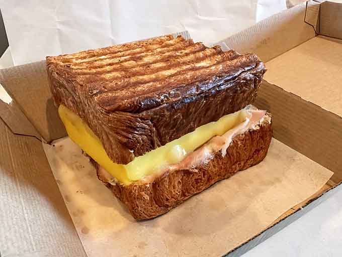Pressed croissant perfection with eggs and cheese, because sometimes the best things in life are also the simplest things.