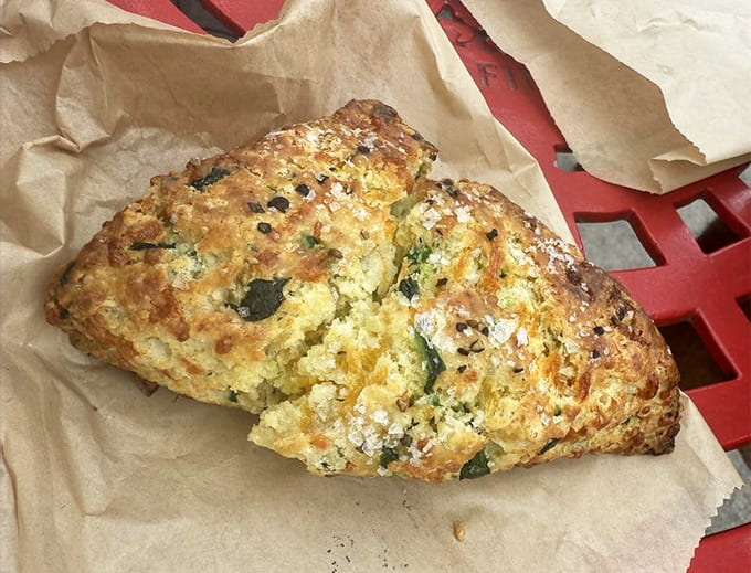 A savory scone packed with spinach and cheddar, proving that Blue Oven Bakery's talents extend far beyond their famous muffins.