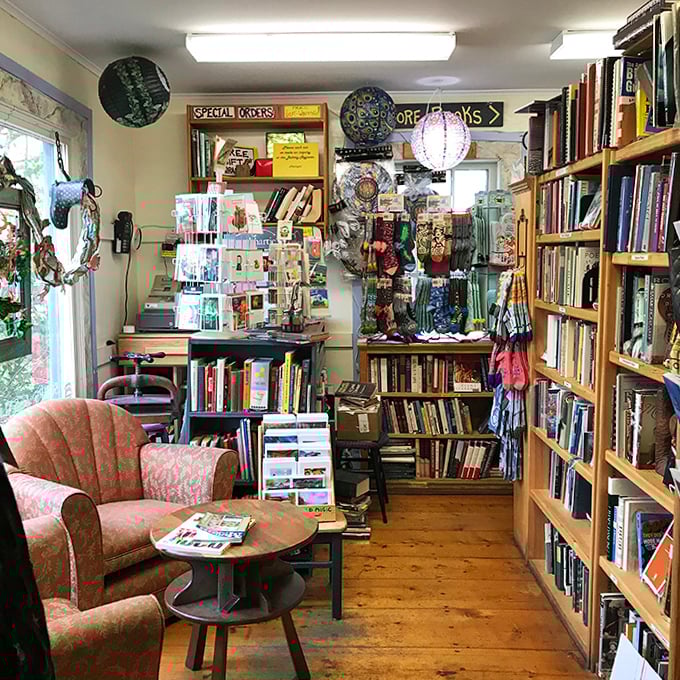 Vintage chairs gather around a wooden table, waiting for readers to pause their literary journeys for conversations or contemplation.