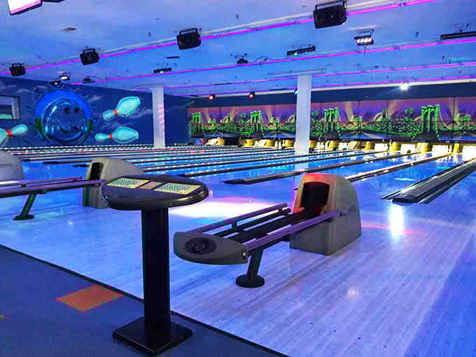 The cosmic bowling alley glows with neon promise, transforming an ordinary game into a space-age experience that makes even gutter balls seem magical.
