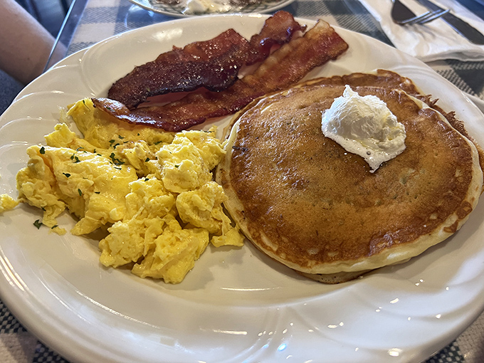 The holy trinity of morning perfection &ndash; fluffy pancakes, scrambled eggs, and bacon so crisp it practically shatters with deliciousness.