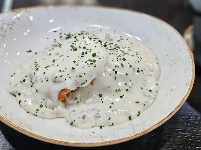 Southern comfort meets Michigan hospitality in these biscuits and gravy &ndash; a creamy, peppery hug for your taste buds.