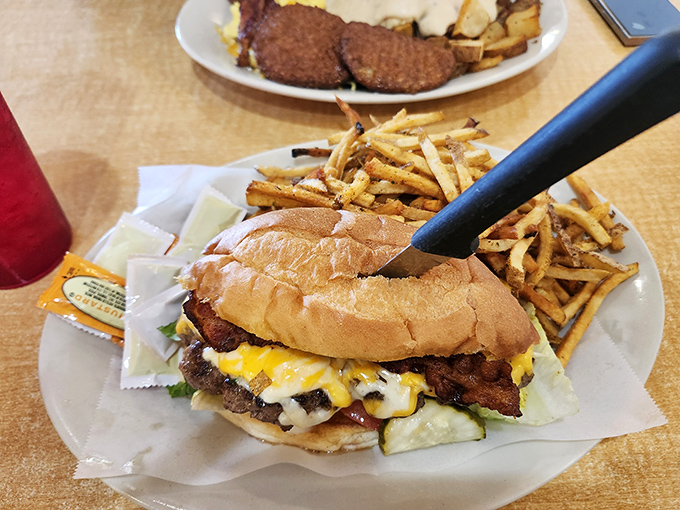 A burger that requires both hands and a strategy &ndash; juicy, cheese-draped, and served with fries that clearly never saw the inside of a freezer.