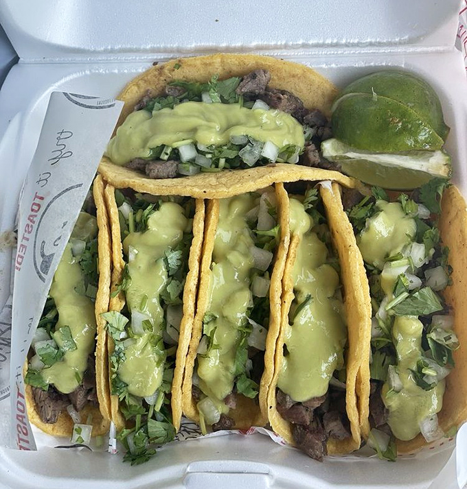 Carne asada tacos adorned with vibrant pickled onions, like jewelry for food, except you can eat it and feel no guilt.