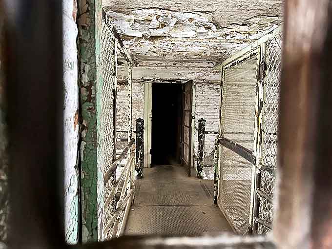 Catwalk Entrance: A portal to another dimension of confinement, where peeling paint and rusted metal tell stories of forgotten lives.