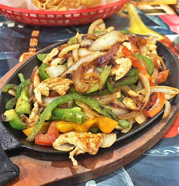 Chicken Fajitas: A colorful fiesta of perfectly saut&eacute;ed peppers and onions dancing alongside tender chicken strips &ndash; just waiting for their tortilla wrap.