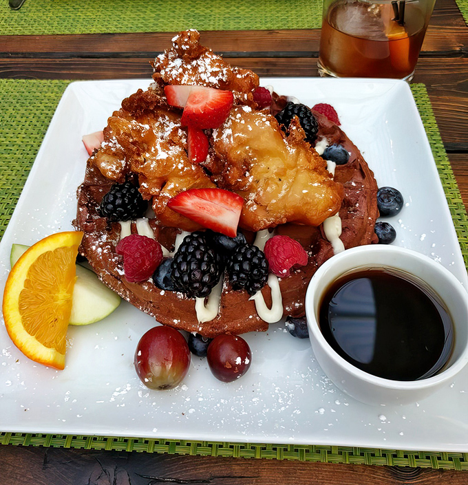 Red velvet waffles bring a playful twist to a classic dish, their vibrant color promising the sweet indulgence that awaits.