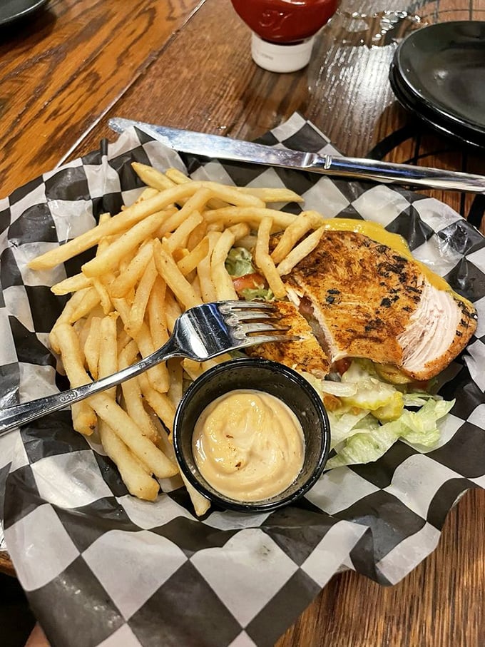 A sandwich worthy of top-secret classification, served with a side of crispy fries and house-made sauce.