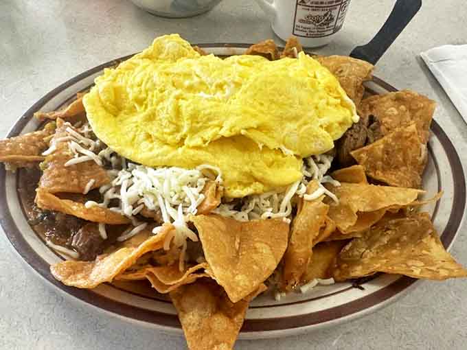 Chilaquiles that dance between crispy and tender, topped with fluffy scrambled eggs and surrounded by tortilla chips for textural contrast.