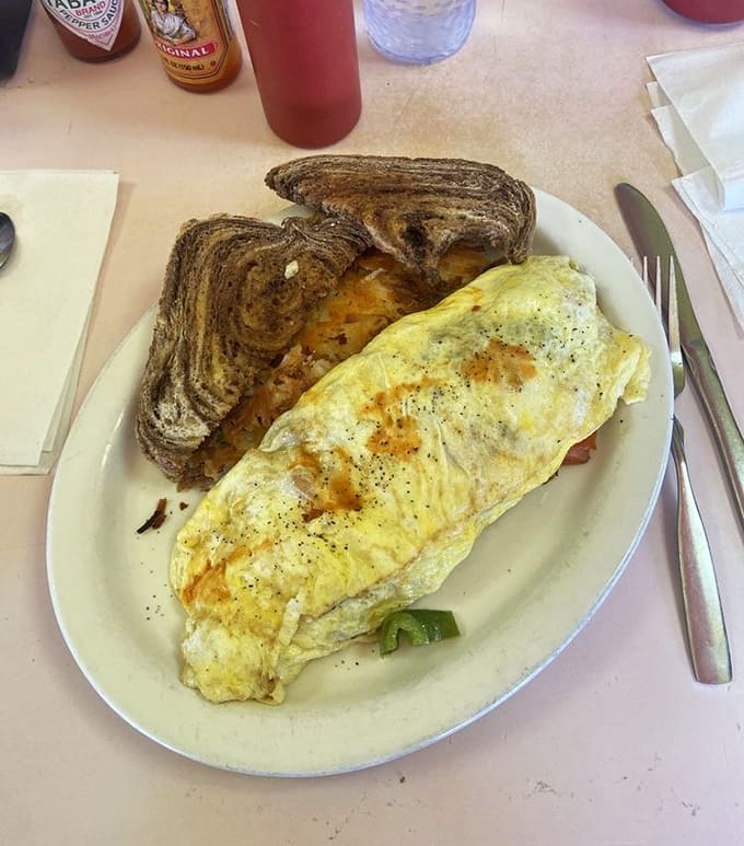 This chorizo omelet with Jack cheese demonstrates the art of egg cookery, golden and puffy with potatoes and toast completing the breakfast dream team.