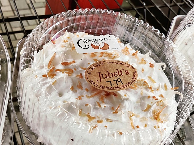 Cloud-like whipped cream crowns this coconut cream masterpiece, with toasted coconut flakes sprinkled like confetti celebrating a victory over ordinary desserts.