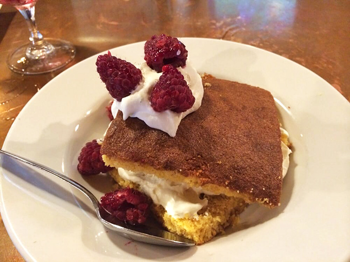 Cornbread transforms into dessert territory with this cinnamon-dusted creation topped with fresh raspberries and cream.