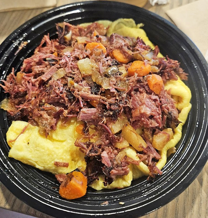 Breakfast alchemy: tender corned beef hash folded into a fluffy omelet creates a protein powerhouse that'll fuel your Maine adventures.