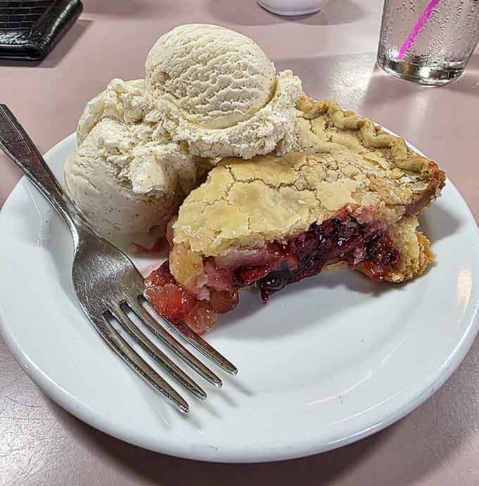 Homemade pie topped with ice cream provides the sweet ending this meal deserves, like the final note of a perfect symphony.