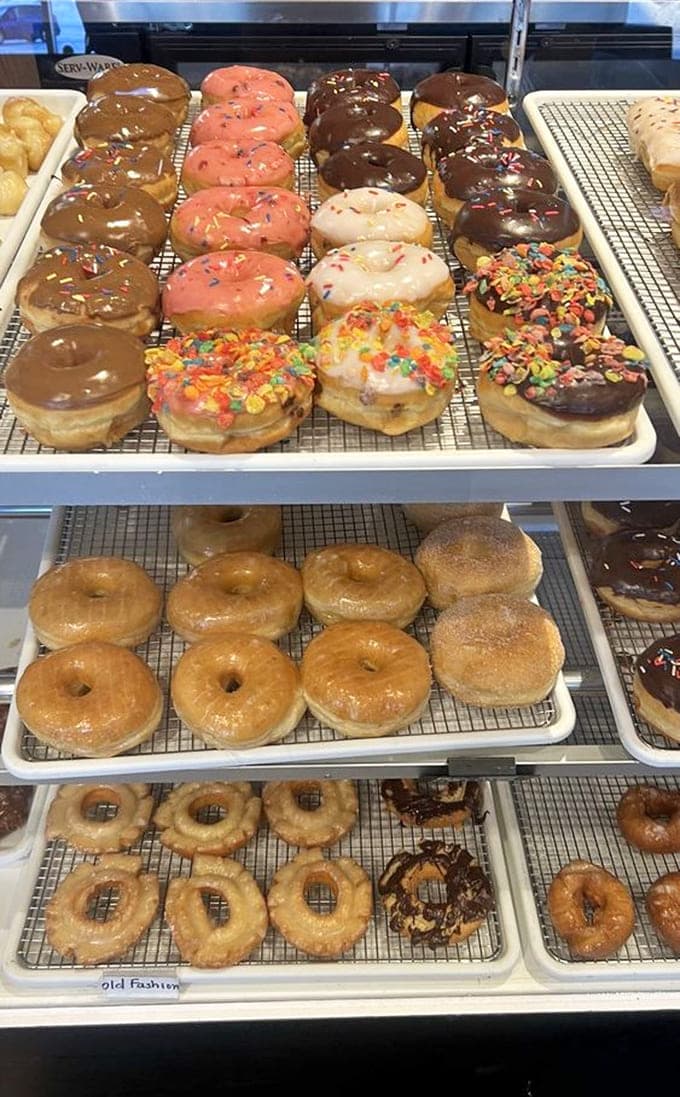 Rows of fresh donuts in the display case tempt visitors with classic glazed, chocolate-topped, and sprinkle-covered varieties.