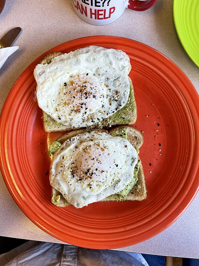 Two slices of eggy heaven topped with fresh avocado, because sometimes simple ingredients create the most memorable meals.