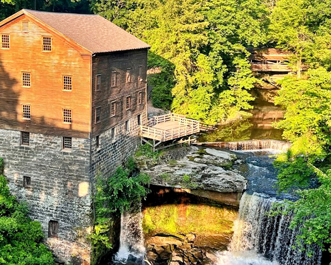 The historic mill and waterfall create a perfect harmony of human ingenuity and natural power, each complementing the other.