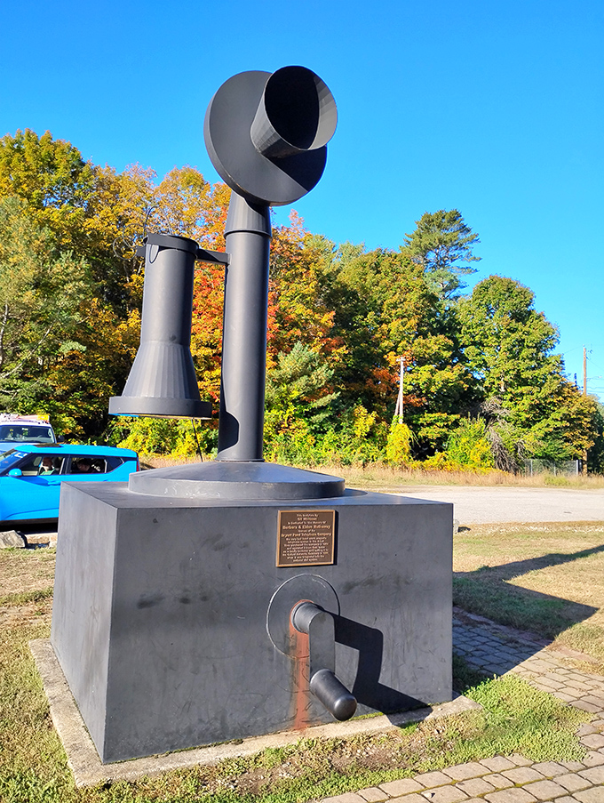 Fall foliage creates a spectacular natural frame for the giant telephone, nature's colorful display competing with this man-made marvel for attention.