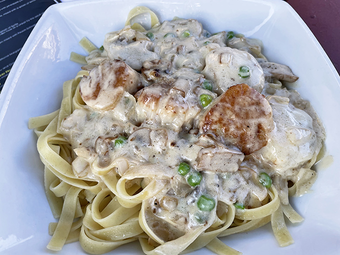 Creamy fettuccine cradles tender scallops and chicken in a rich sauce &ndash; comfort food elevated to roadside attraction status.