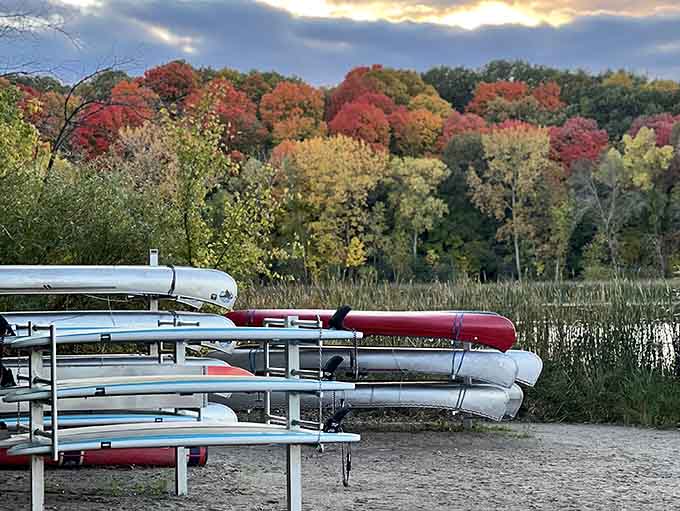 Kayaks and canoes rest like colorful sleeping dragons, waiting to carry you across waters that promise adventure without danger.