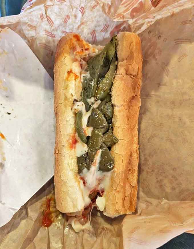 Meatball perfection nestled in a fresh roll with melted cheese and vibrant peppers &ndash; comfort food that speaks directly to your soul.