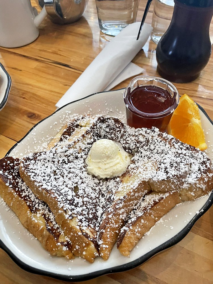 French toast transformed into a celebration &ndash; vanilla ice cream melts into maple-soaked bread dusted with powdered sugar.