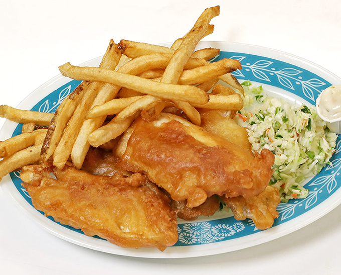 Behold, the holy trinity of comfort food: golden fish, crispy chips, and a coleslaw sidekick to cut the guilt. 