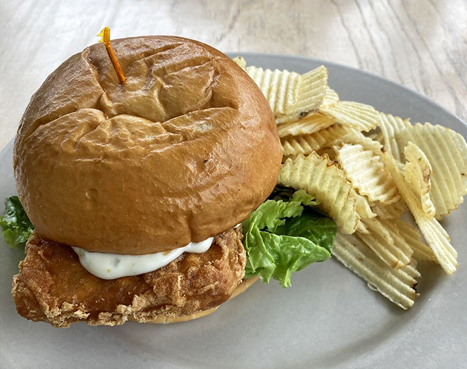 The fried haddock sandwich &ndash; where crispy meets soft meets tangy meets perfect. Served with chips because some traditions just work.