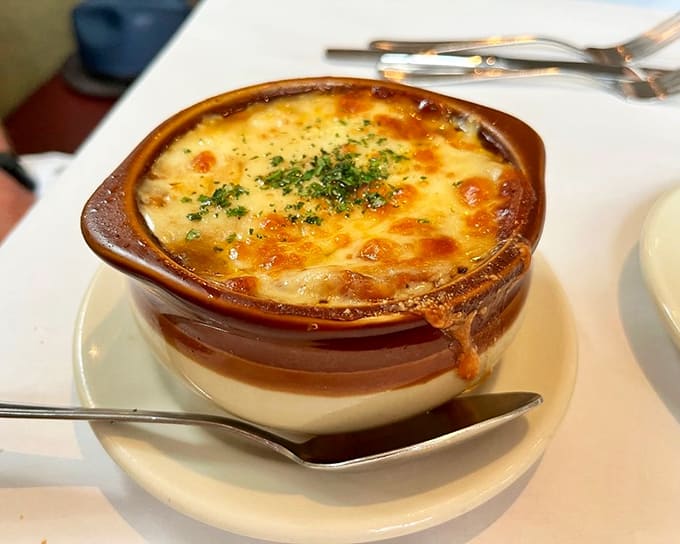 French onion soup bubbles under a blanket of melted cheese, the kind of comfort food that makes you understand why this classic never goes out of style.