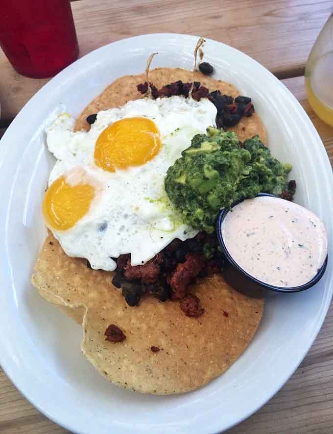 Traditional Huevos Rancheros done right, with fresh avocado and perfectly cooked eggs creating the kind of breakfast that ruins all other breakfasts forever.