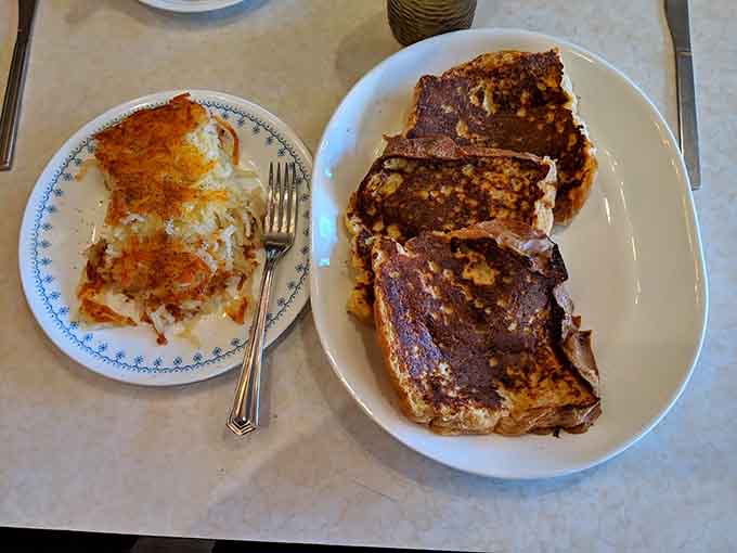 French toast thick enough to require structural engineering and delicious enough to justify whatever food coma follows, no regrets allowed here.